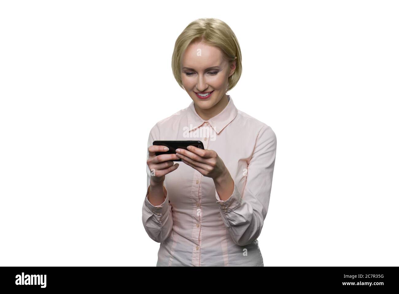 Female office worker playing games on her phone during time break Stock ...