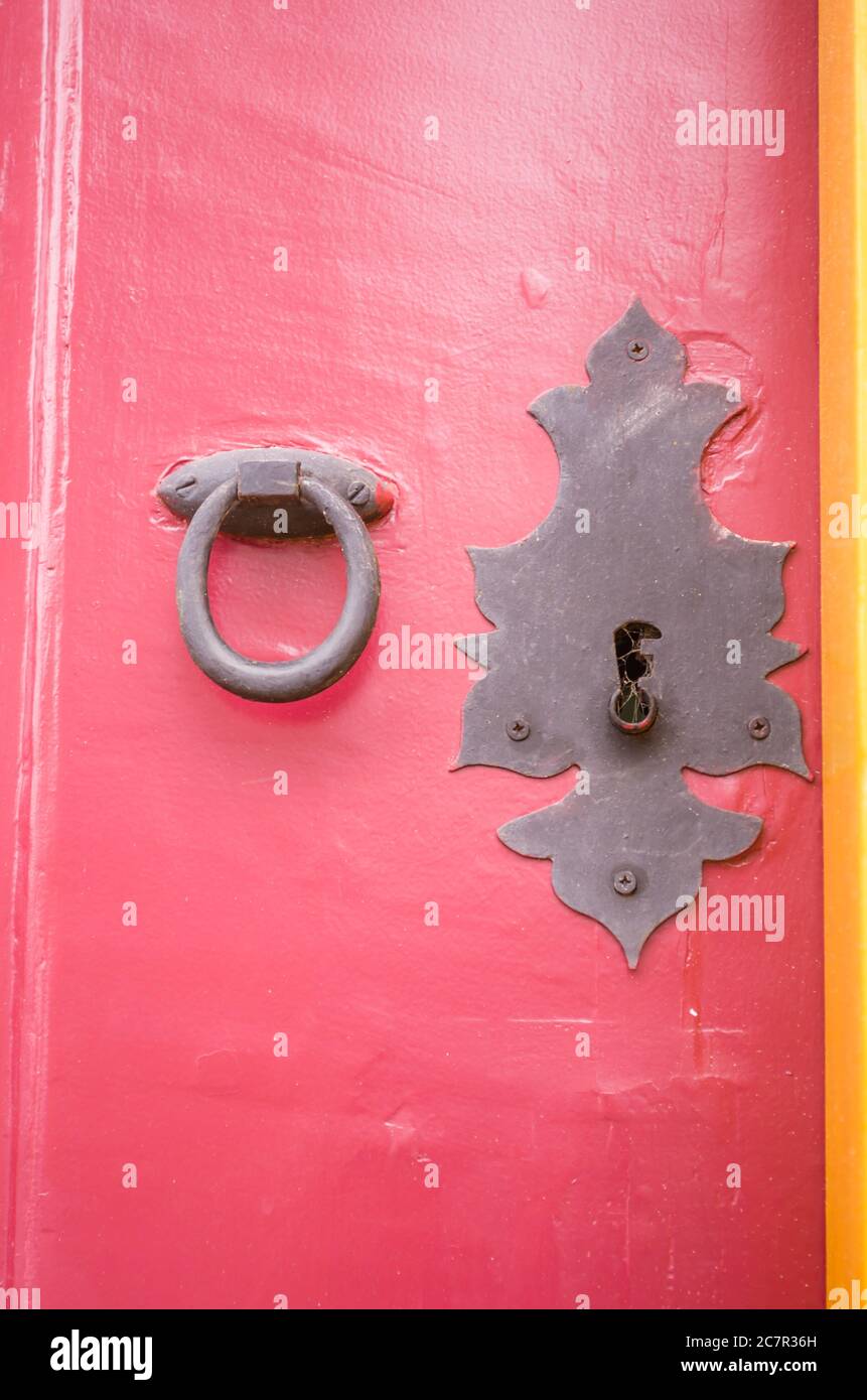 Vertical shot of medieval old knobs and locks on a red door Stock Photo ...