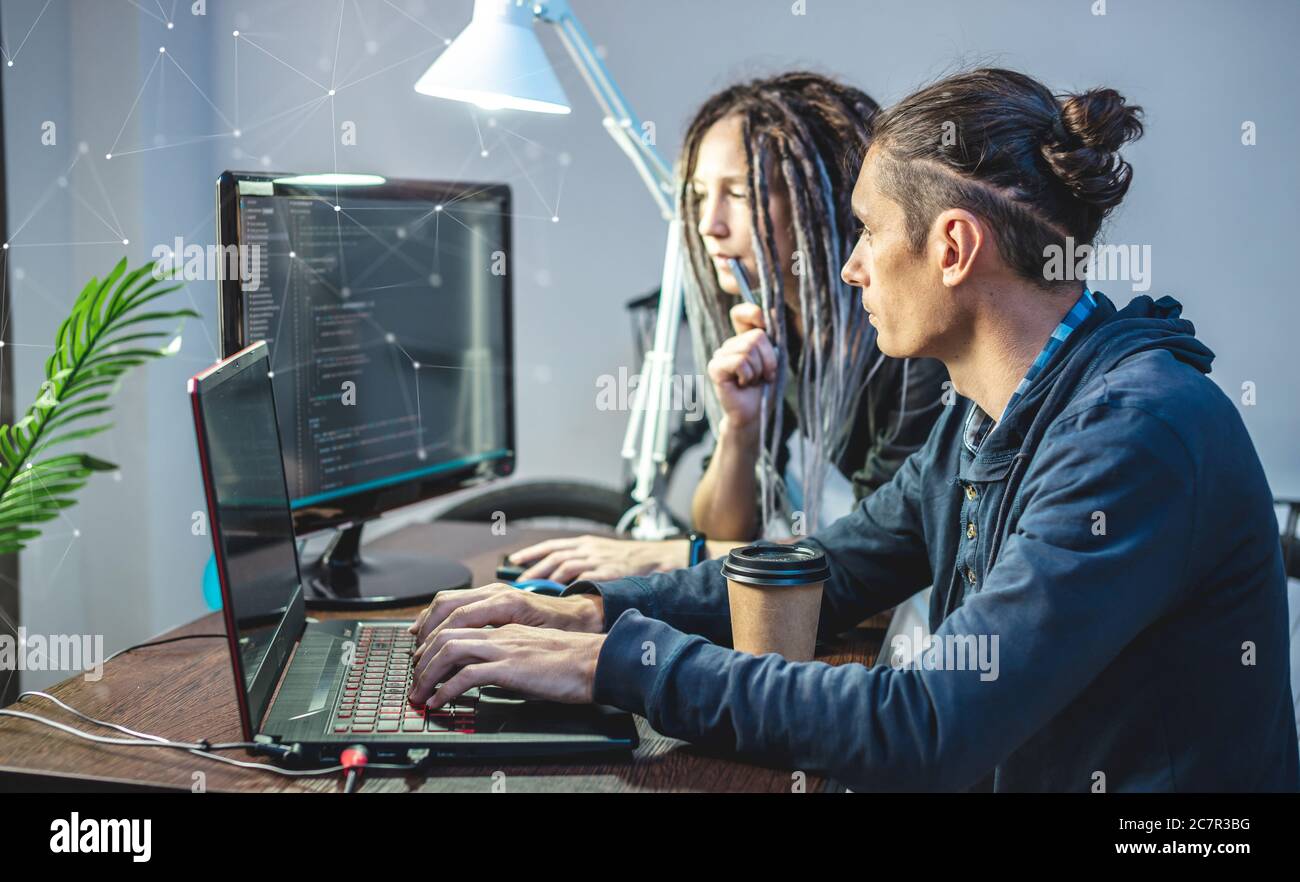 Programmers are developing software by working with software code together. Team work. Modern ...