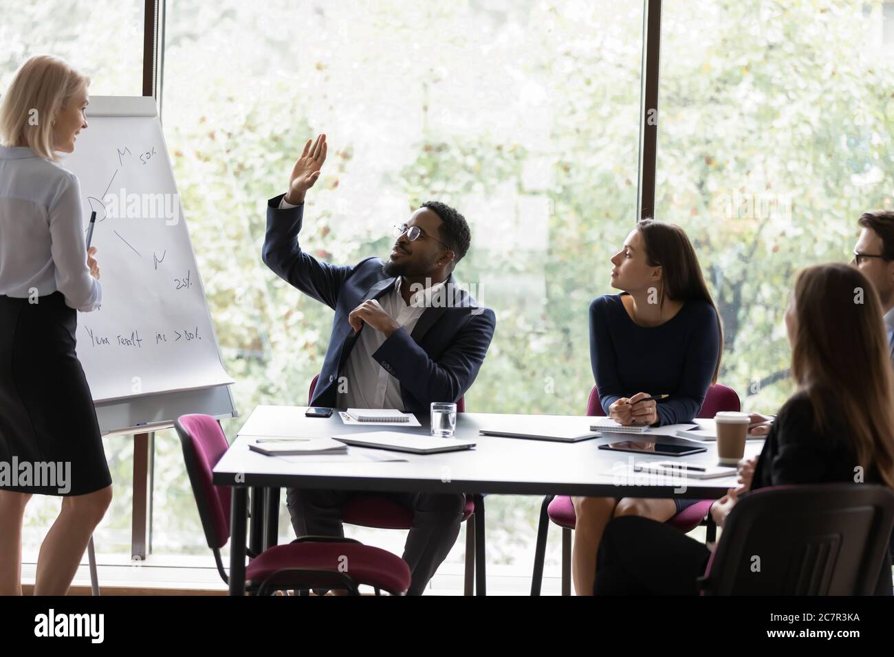 African raise arm having question or proposal participating in seminar ...