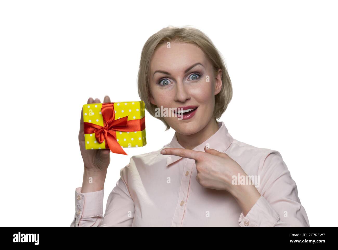 Happy surprised blond woman holding little present box in her one hand ...