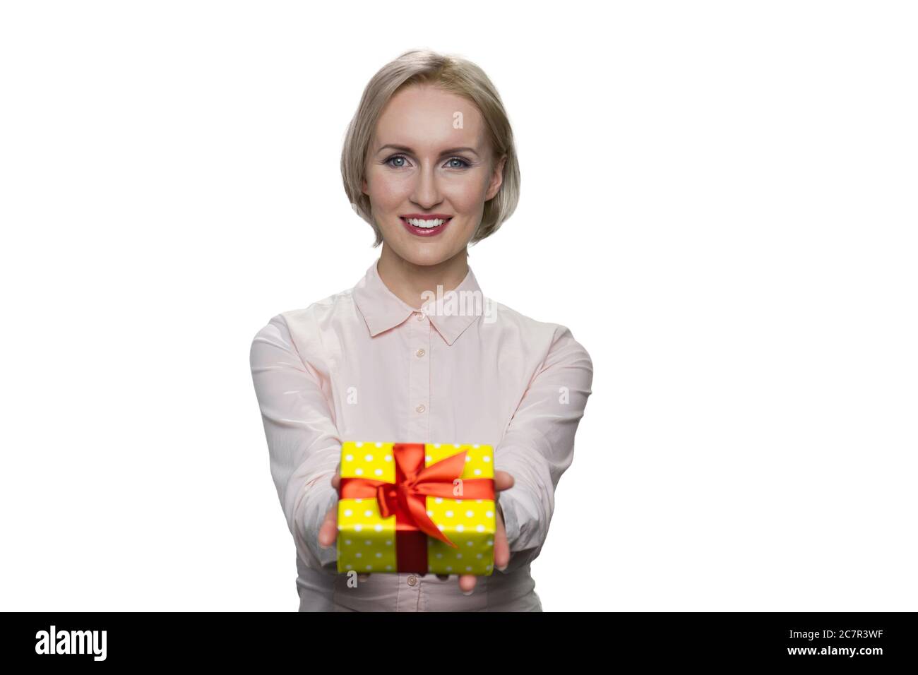 Happy girl gives a small gift on white background Stock Photo - Alamy
