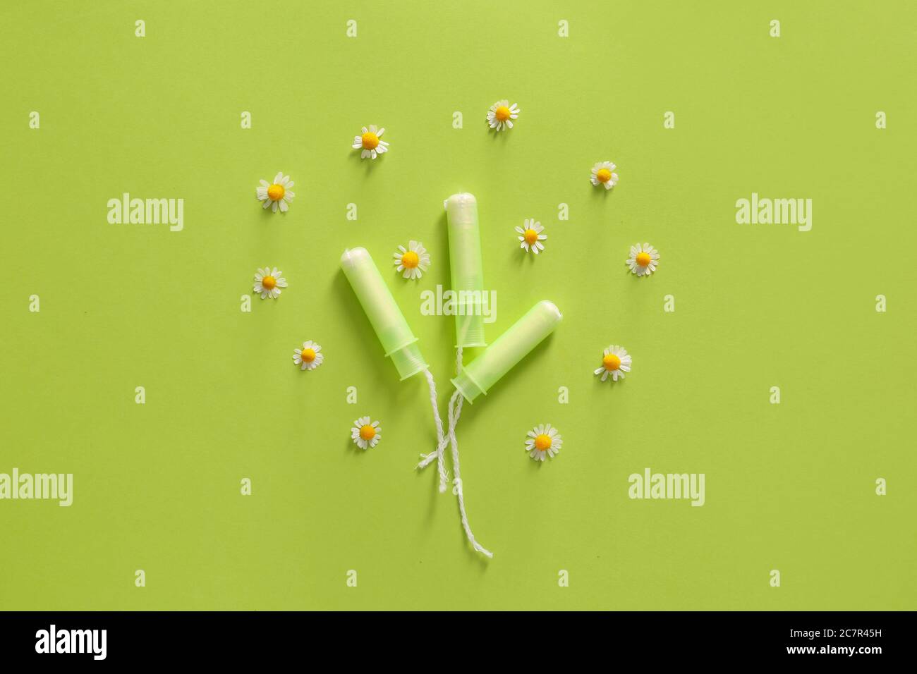 Menstrual tampons with chamomile flowers on color background Stock ...