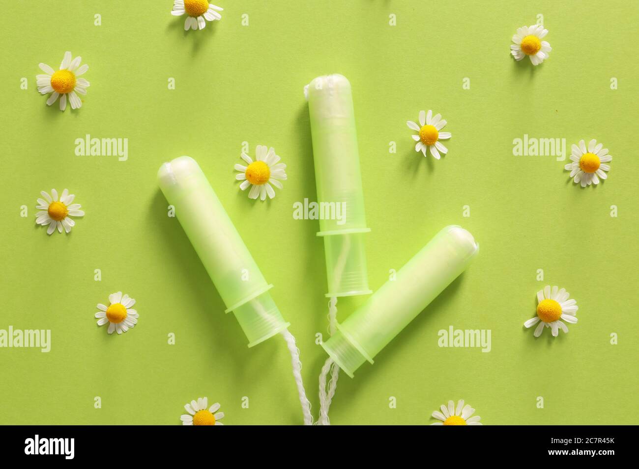 Menstrual tampons with chamomile flowers on color background Stock ...