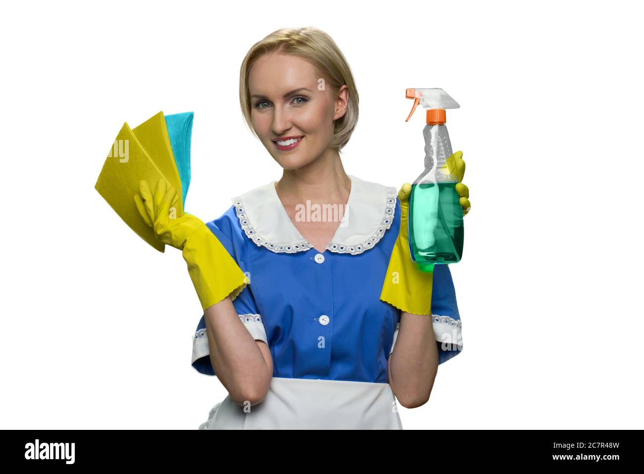 Smiling blonde maid holding rag and spray cleaner gun white background ...