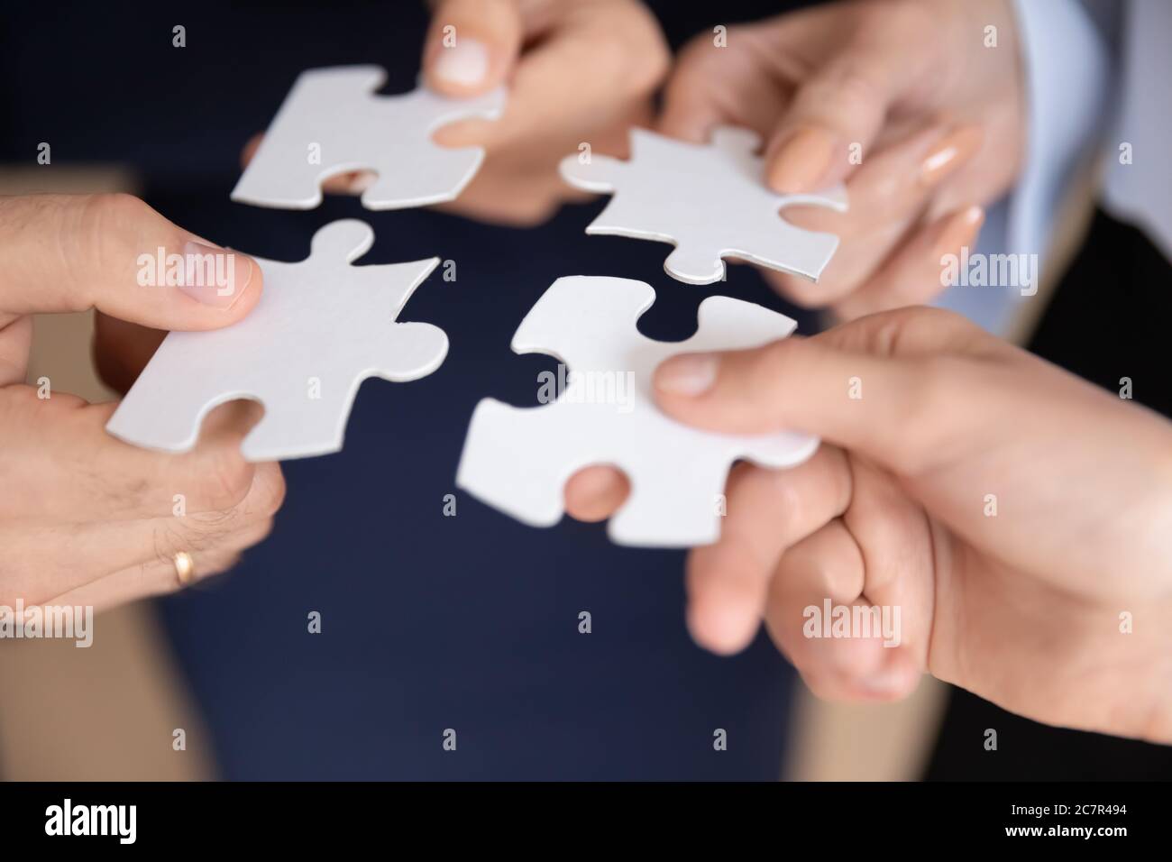 Closeup hands holding white pieces of puzzles find right solution Stock ...