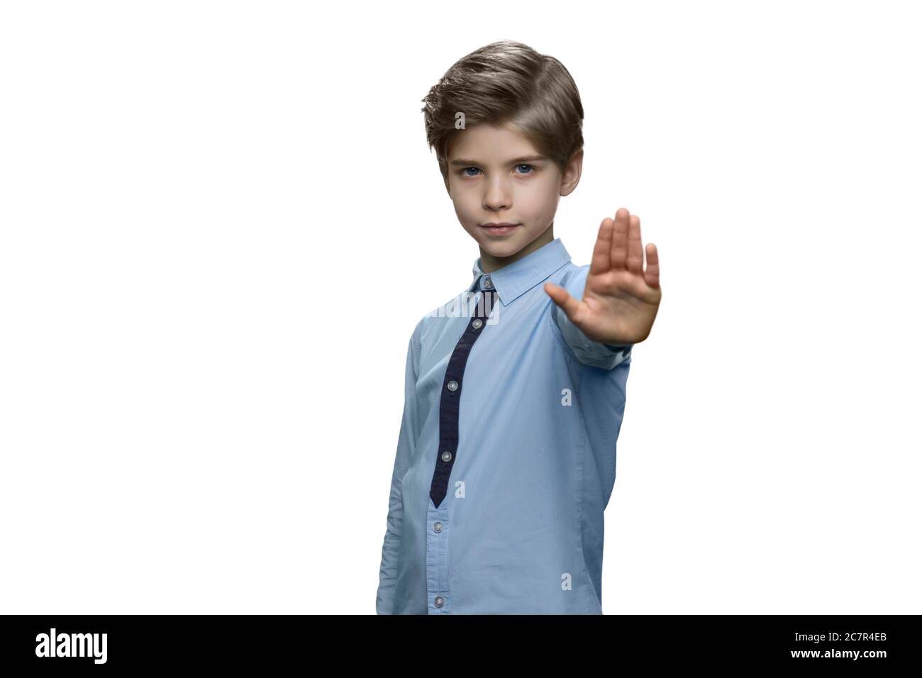 Boy making stop gesture with his palm on whte background Stock Photo ...