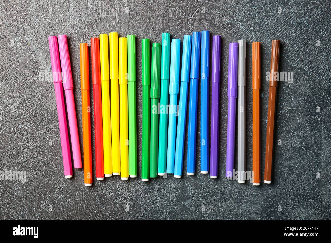Colorful markers on grey background Stock Photo - Alamy