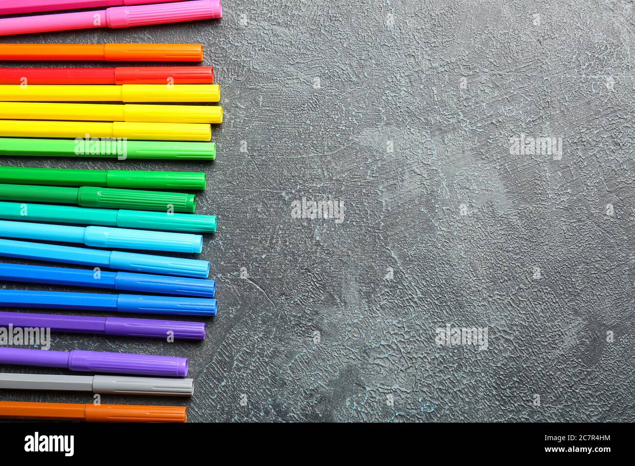 Colorful markers on grey background Stock Photo - Alamy
