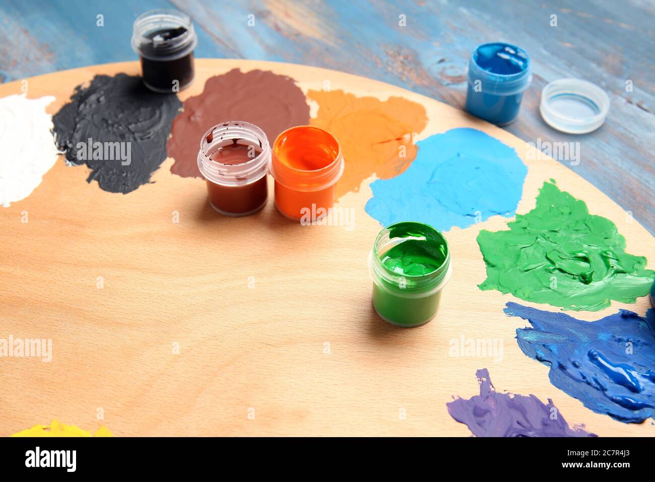 Paints and artist's palette on table, closeup Stock Photo - Alamy