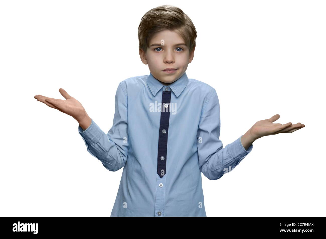 Confused boy giving I dont know gesture on white background Stock Photo ...
