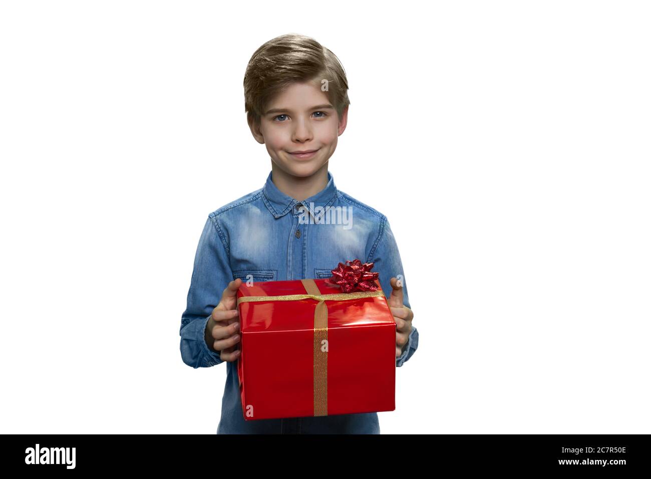 Happy boy holds big red gift box on white background Stock Photo - Alamy