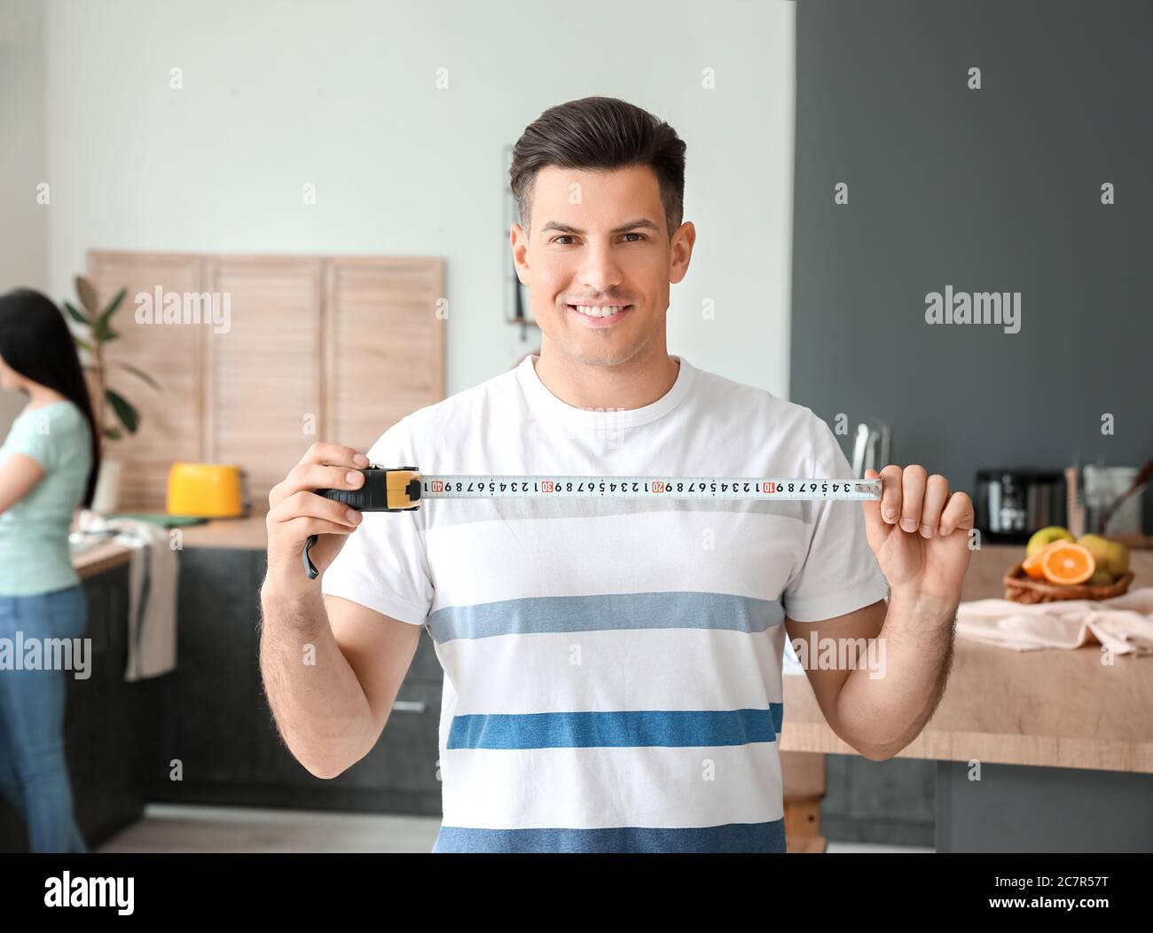 Man woman measuring length hi-res stock photography and images - Alamy
