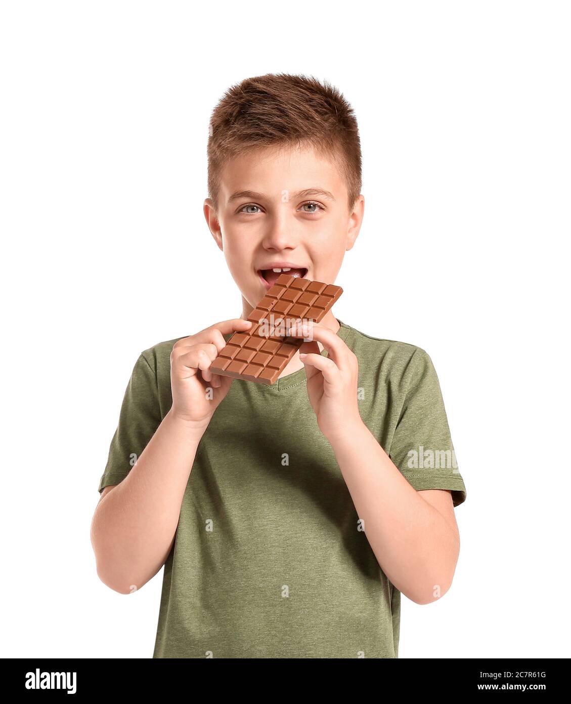 Cute little boy eating chocolate on white background Stock Photo - Alamy