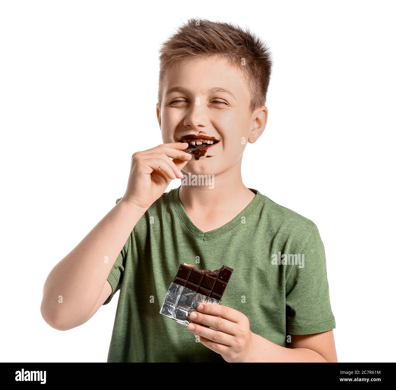 Cute little boy eating chocolate on white background Stock Photo - Alamy