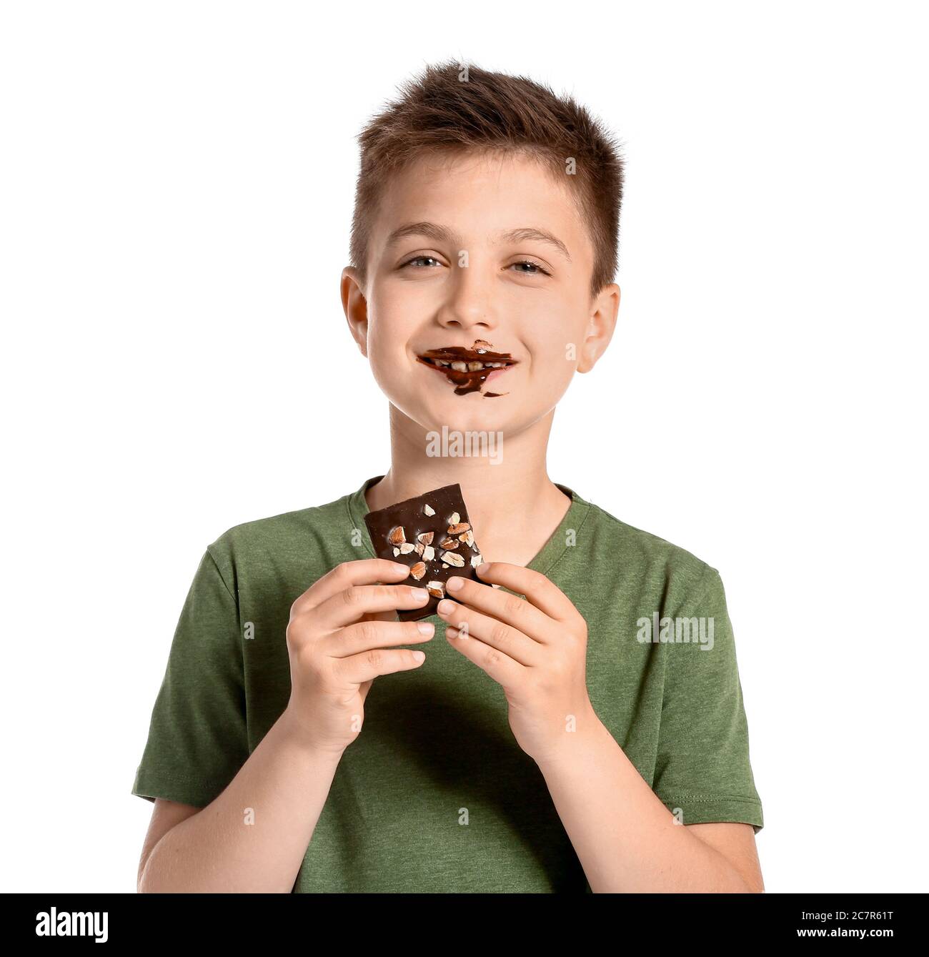 Cute little boy eating chocolate on white background Stock Photo - Alamy