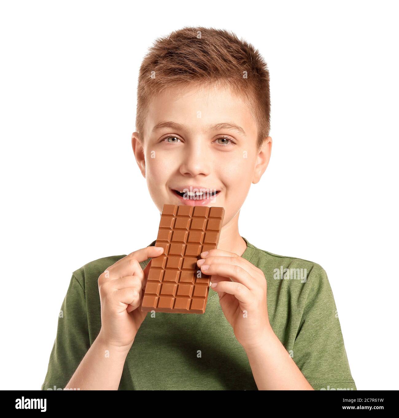 Cute little boy eating chocolate on white background Stock Photo - Alamy