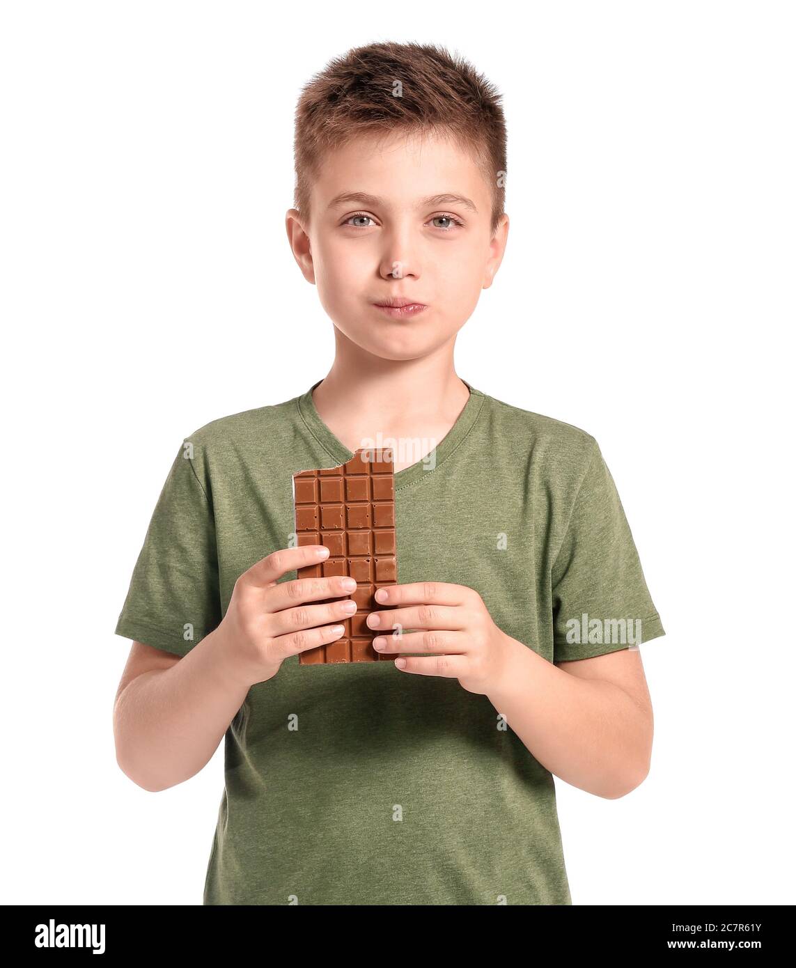 Cute little boy eating chocolate on white background Stock Photo - Alamy