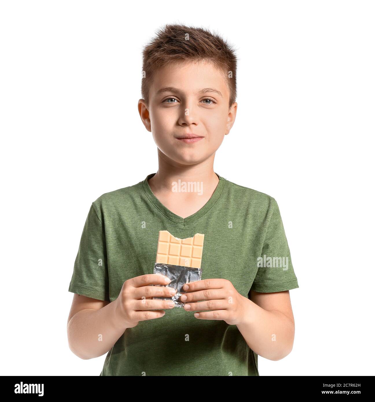 Cute little boy eating chocolate on white background Stock Photo - Alamy