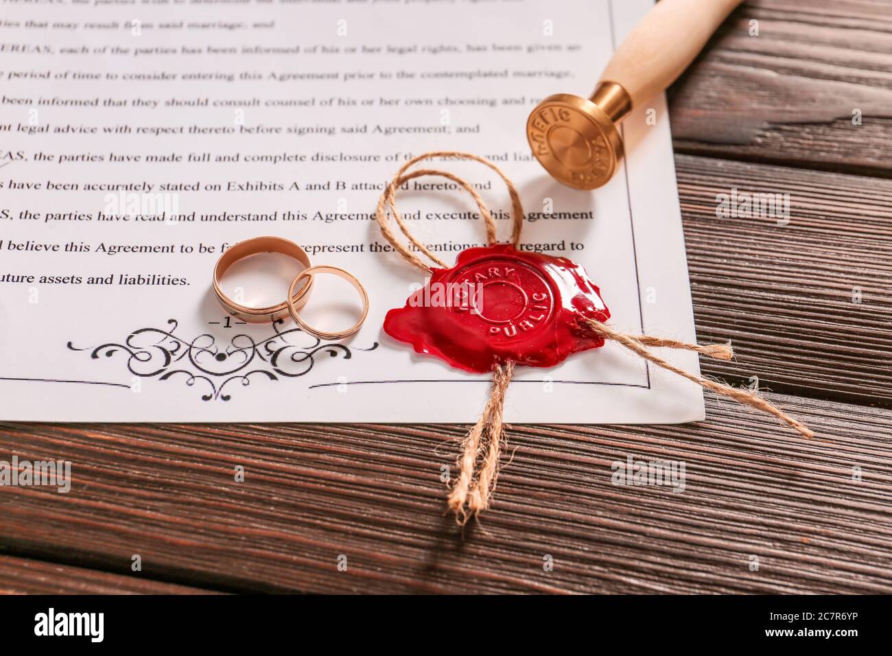 Marriage contract with wax seal stamp and wedding rings on table Stock ...