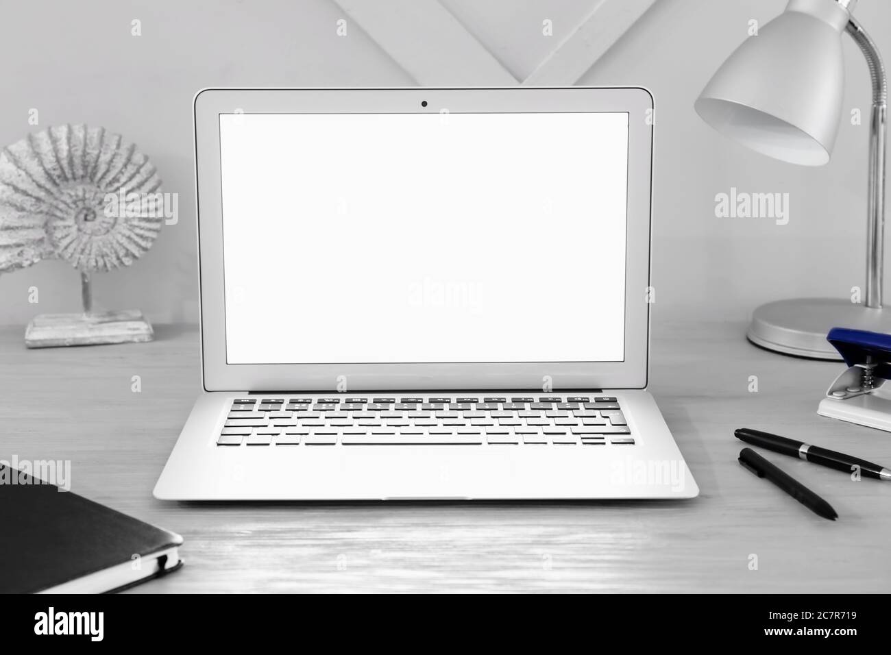 Modern laptop on table in room Stock Photo - Alamy