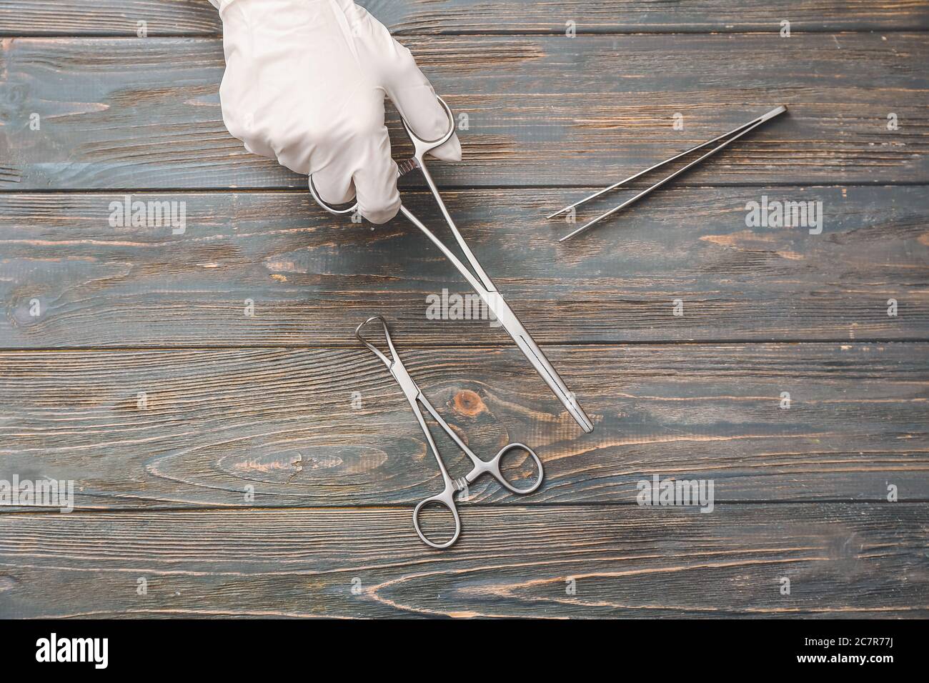 Hand of surgeon and tools on wooden background Stock Photo - Alamy