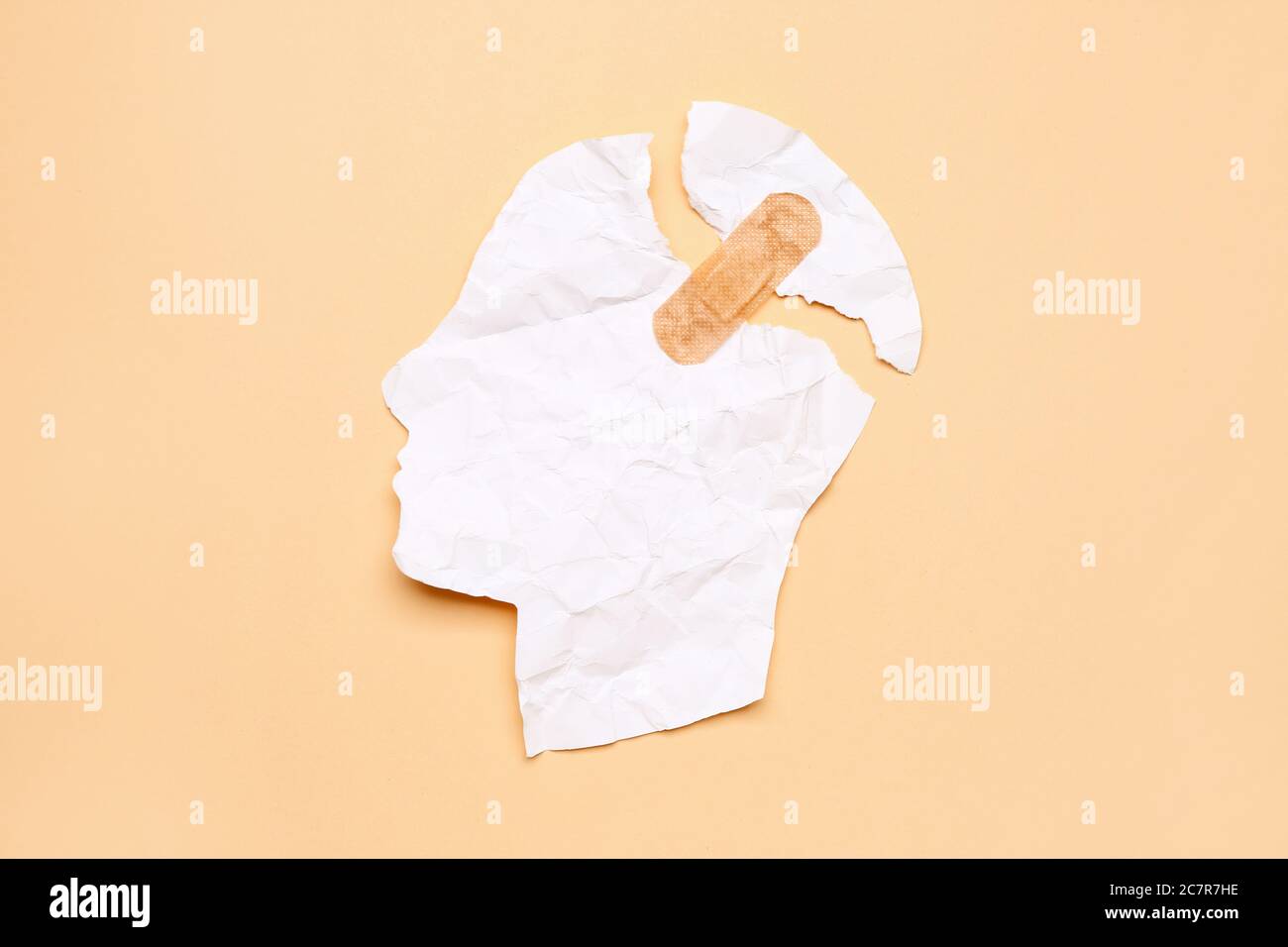 Torn paper human head with plaster on color background. Concept of ...