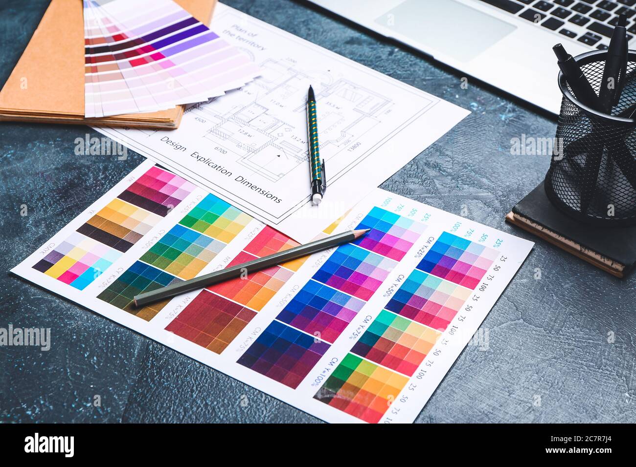 Color palettes with building plan and laptop on dark background Stock ...