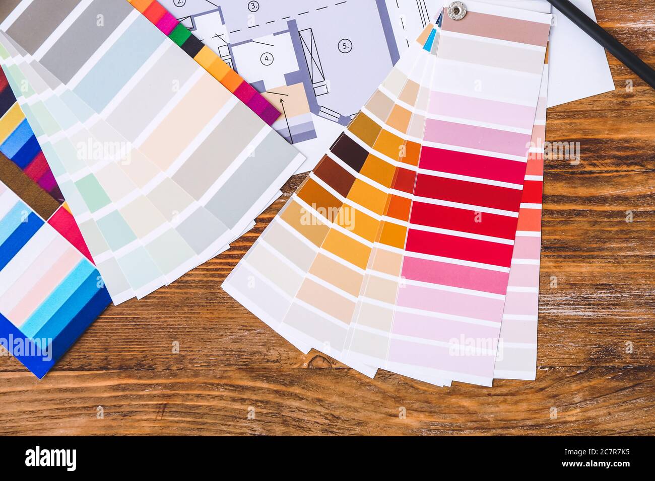 Color palettes with building plan on wooden background Stock Photo - Alamy