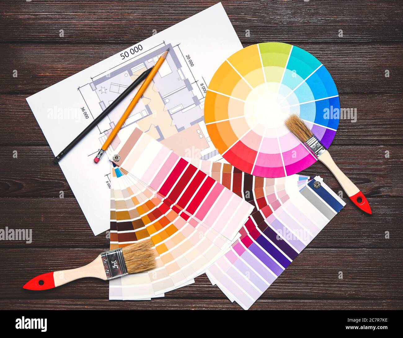 Color palettes with building plan and paint brushes on wooden ...