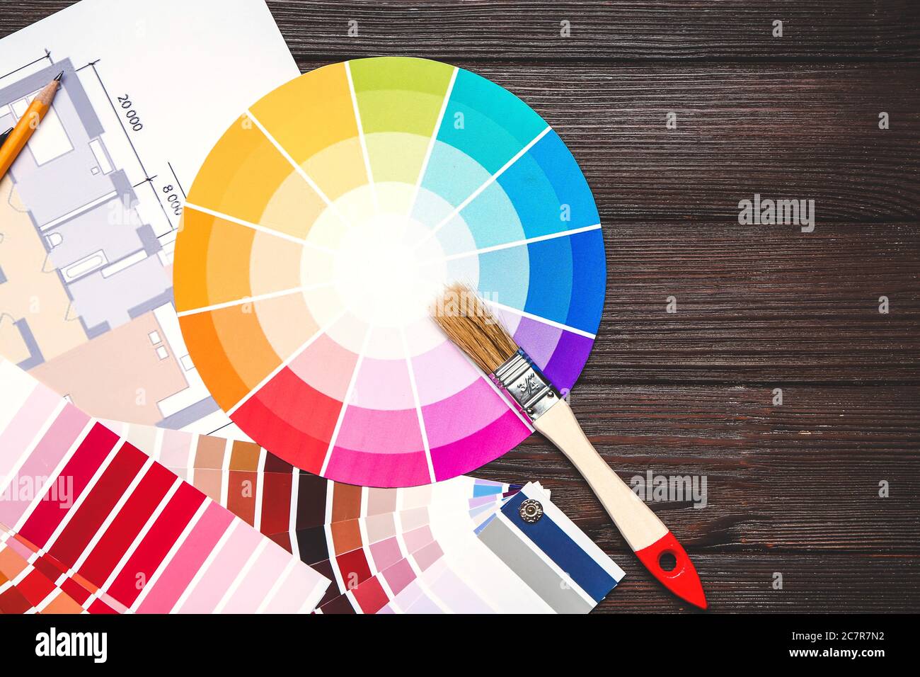 Color palettes with building plan and paint brush on wooden background ...