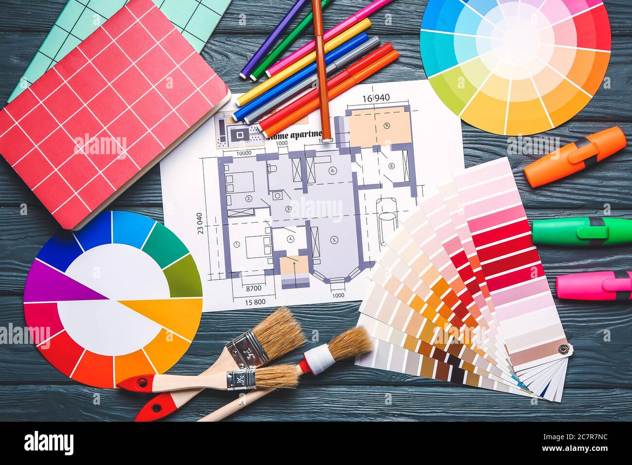 Color palettes with building plan and paint brushes on wooden ...