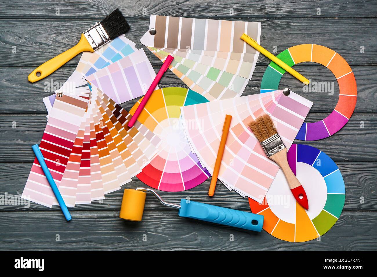 Color palettes with roller and paint brushes on wooden background Stock ...