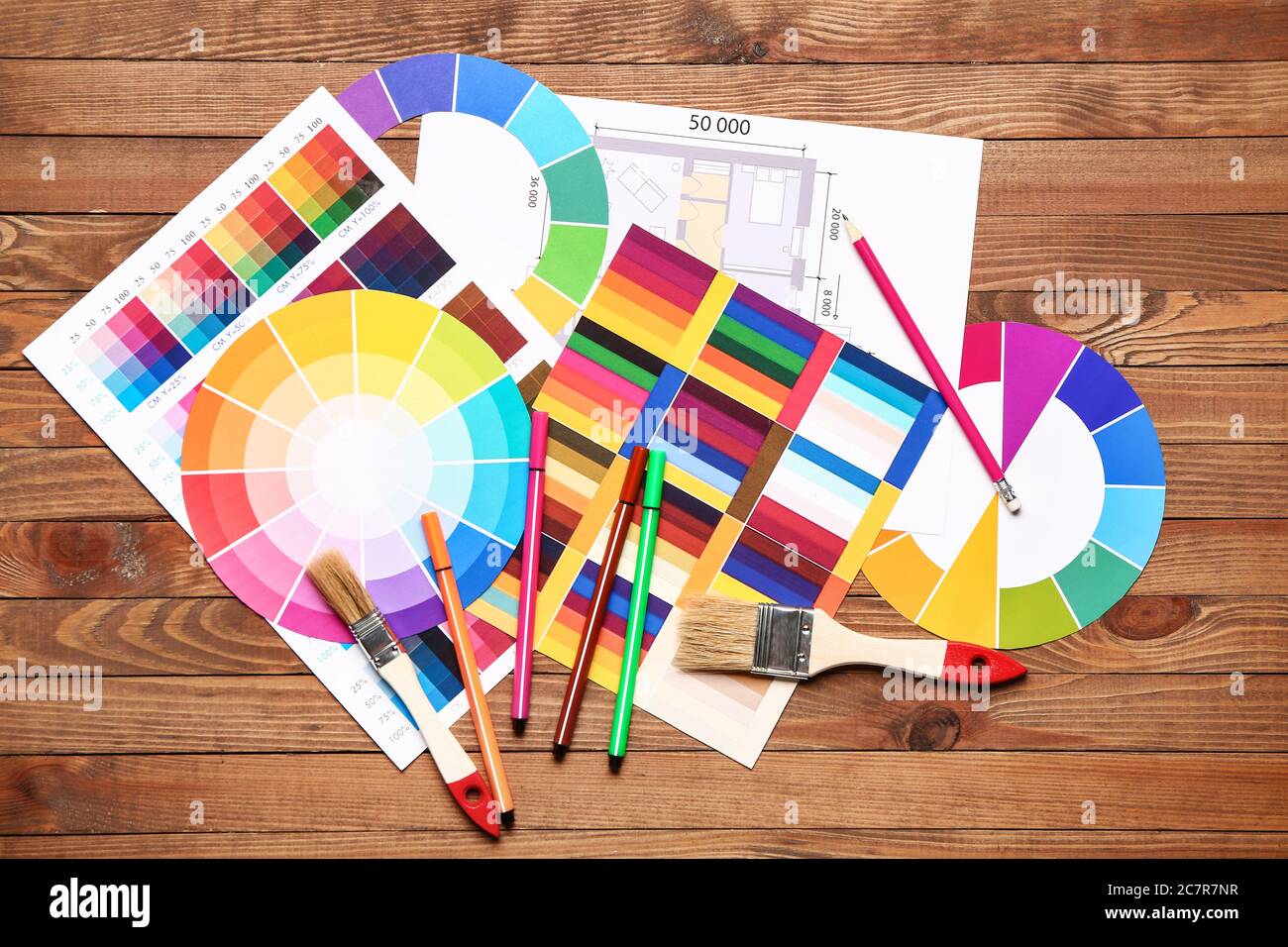 Color palettes with building plan and paint brushes on wooden ...
