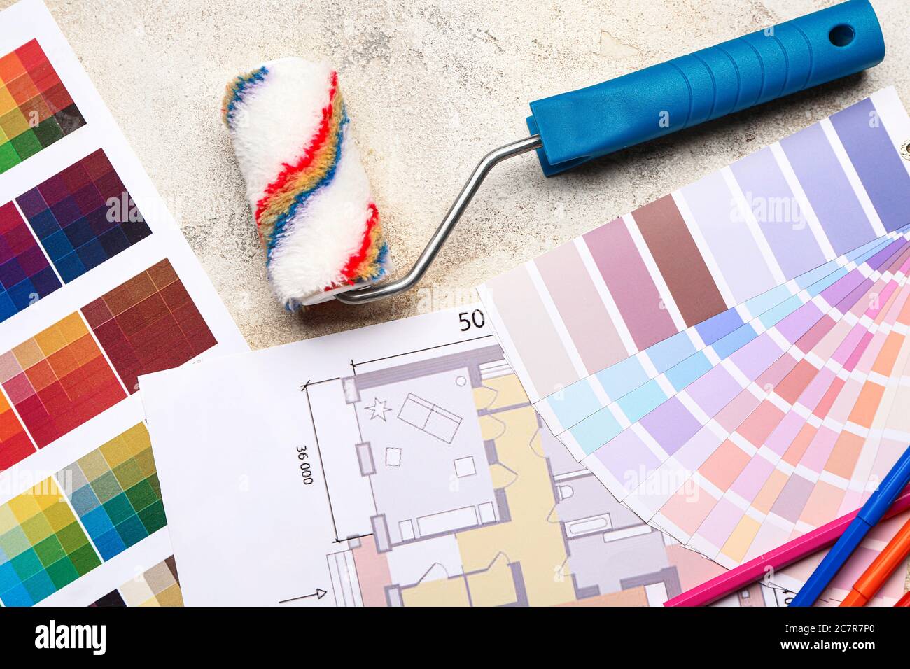 Color palettes with building plan and paint roller on light background ...