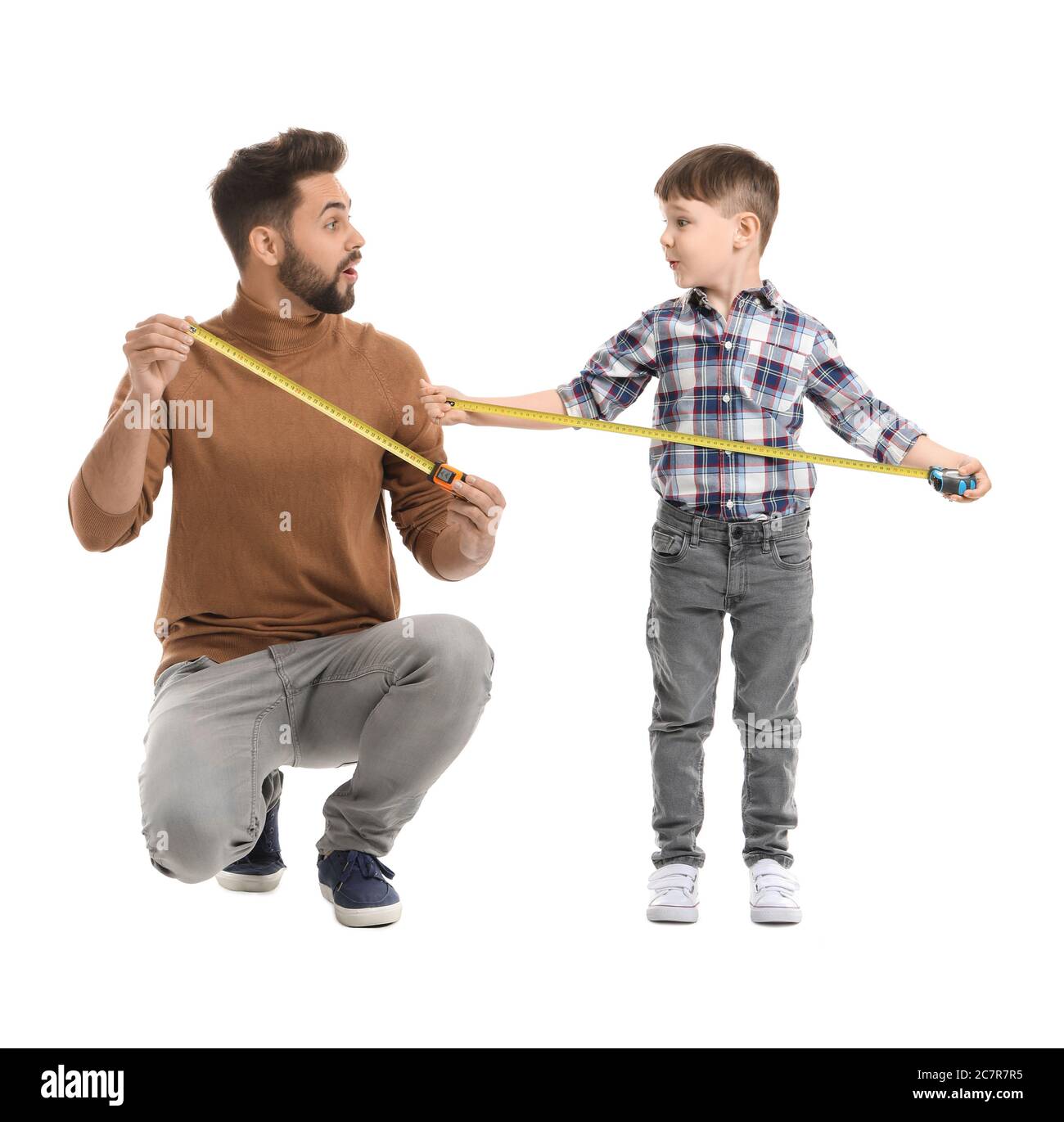 Surprised father and son with measuring tapes on white background Stock ...