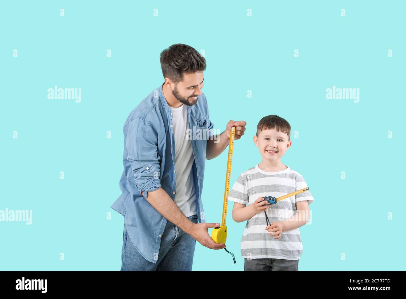 Father measuring son height ruler hi-res stock photography and images ...