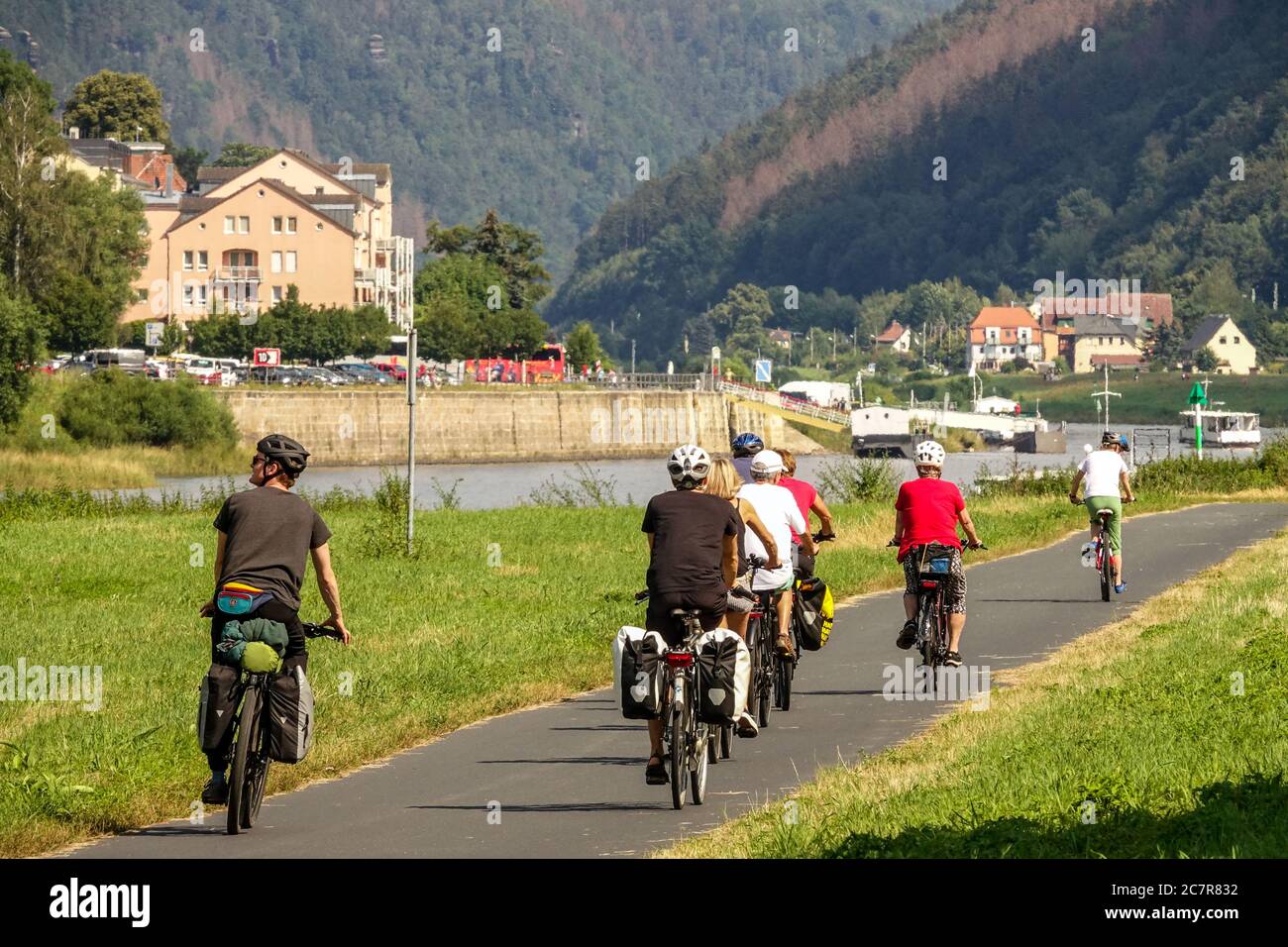 Group of people ride on cycle path leading along Elbe river Saxony ...