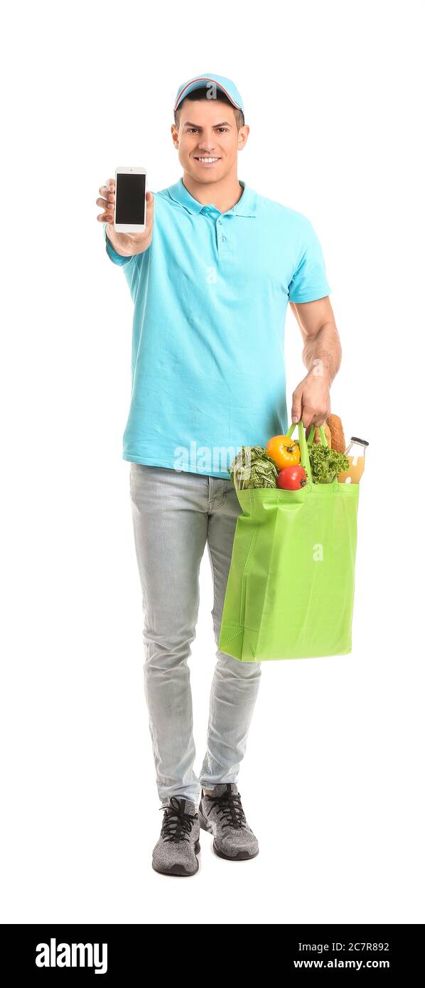 Delivery man with food in bag and mobile phone on white background ...