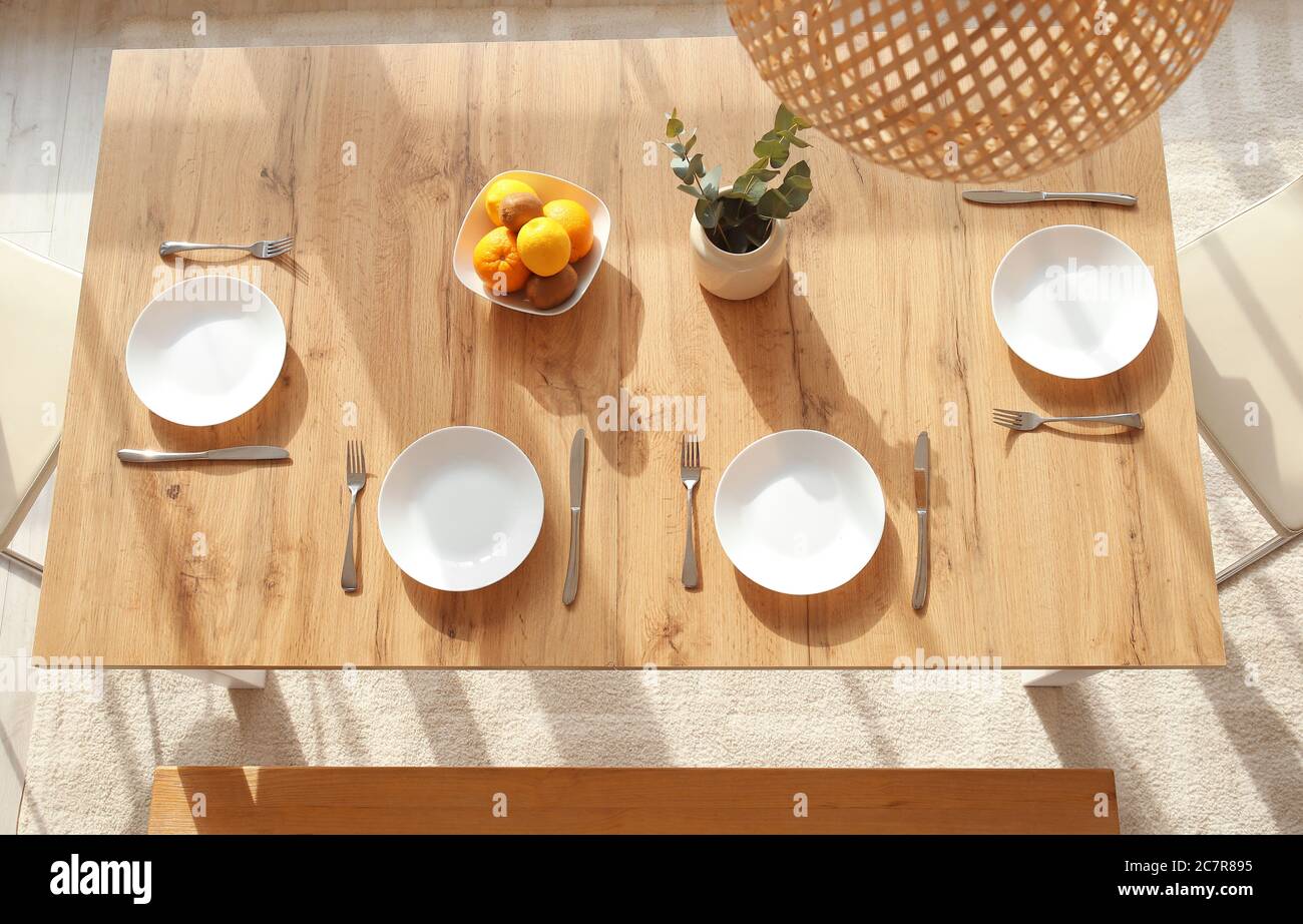 Table set in modern stylish dining room, top view Stock Photo - Alamy