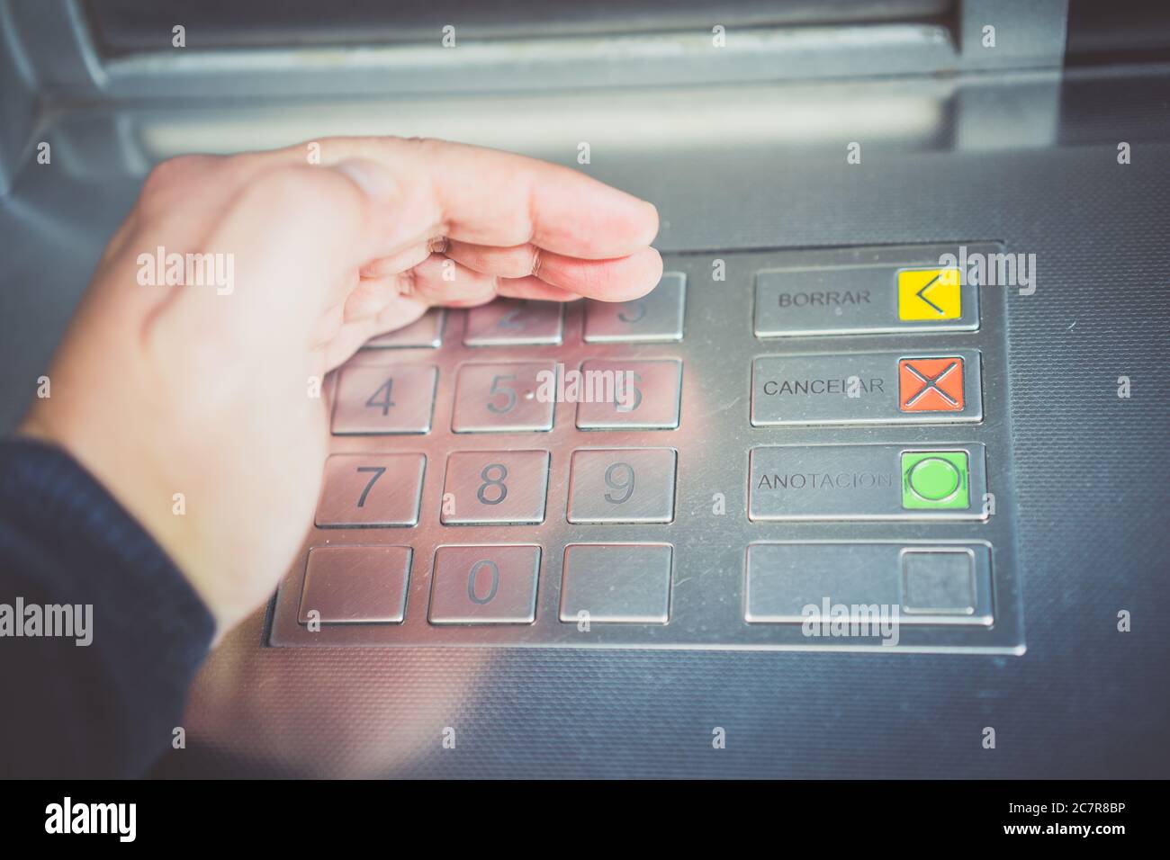 Closeup shot of a hand shielding an ATM machine keypad Stock Photo - Alamy