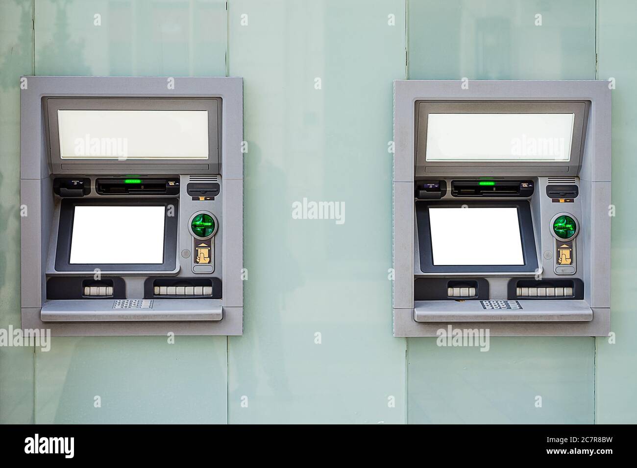 Isolated shot of two gray atm machines on a light blue wall Stock Photo ...