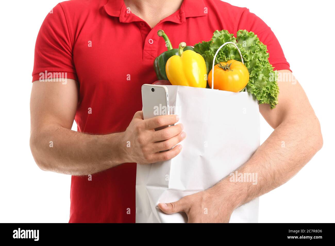 Delivery man with food in bag and mobile phone on white background ...