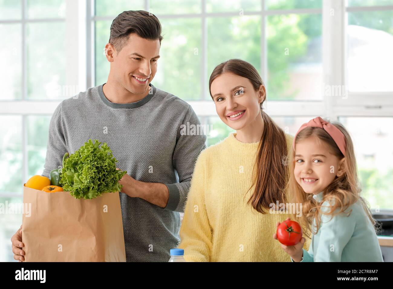 Family unpacking fresh products from market in kitchen Stock Photo - Alamy