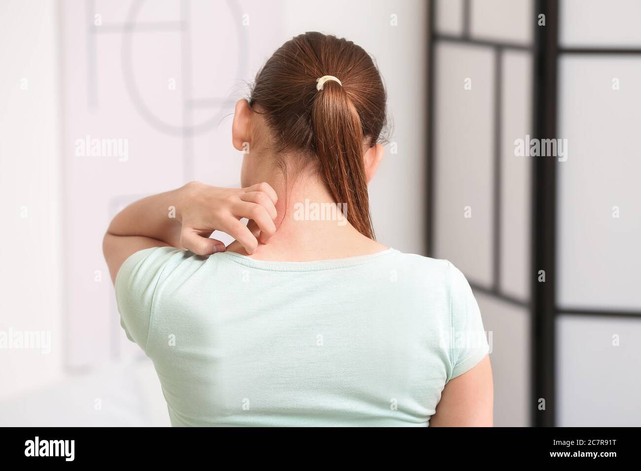 Young woman scratching her back hi-res stock photography and images - Alamy