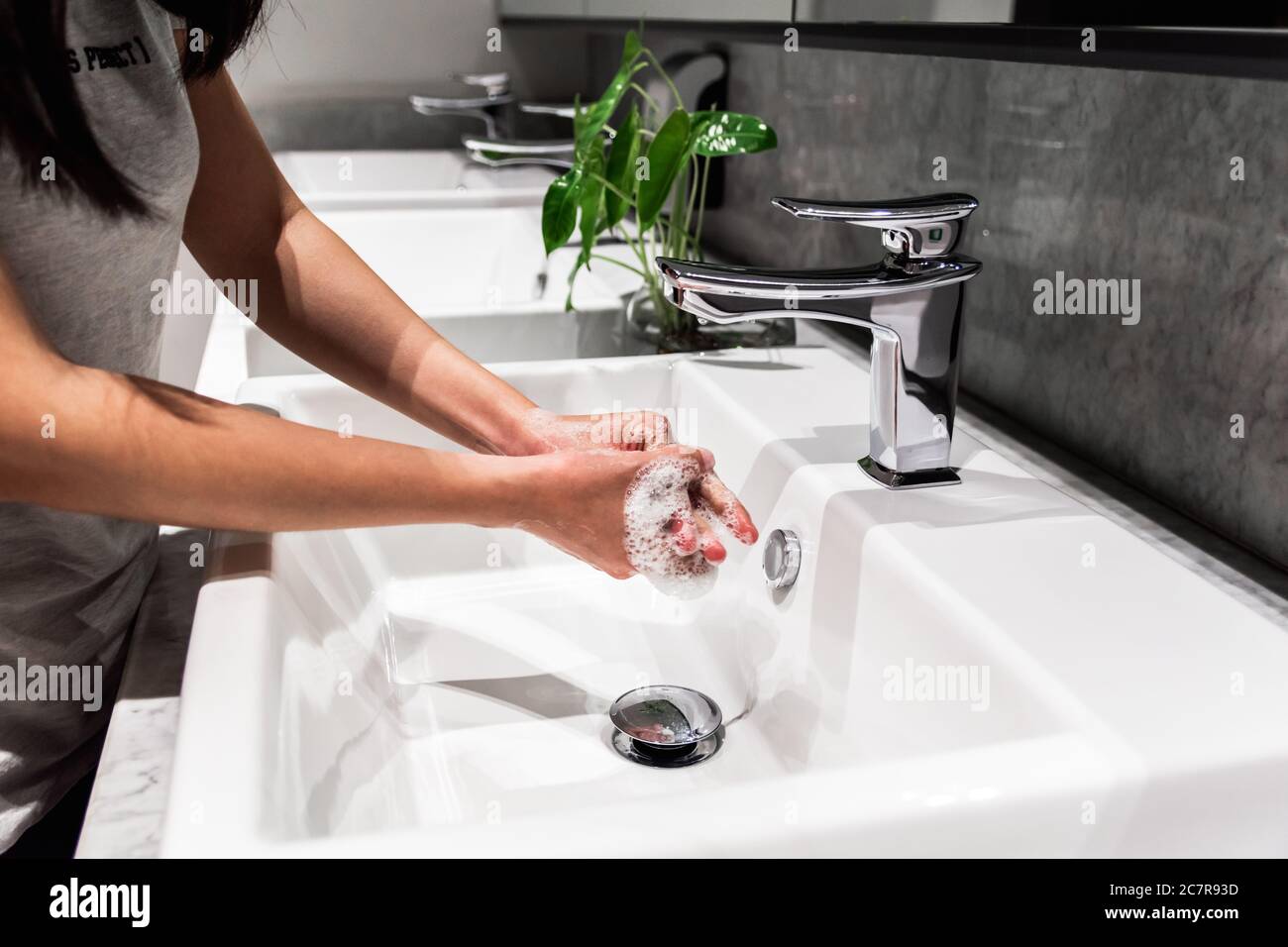 Young asian women washing hand with soap in faucet. New normal ...