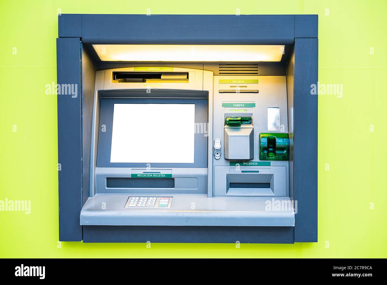 Isolated shot of an ATM machine on a light green background Stock Photo ...