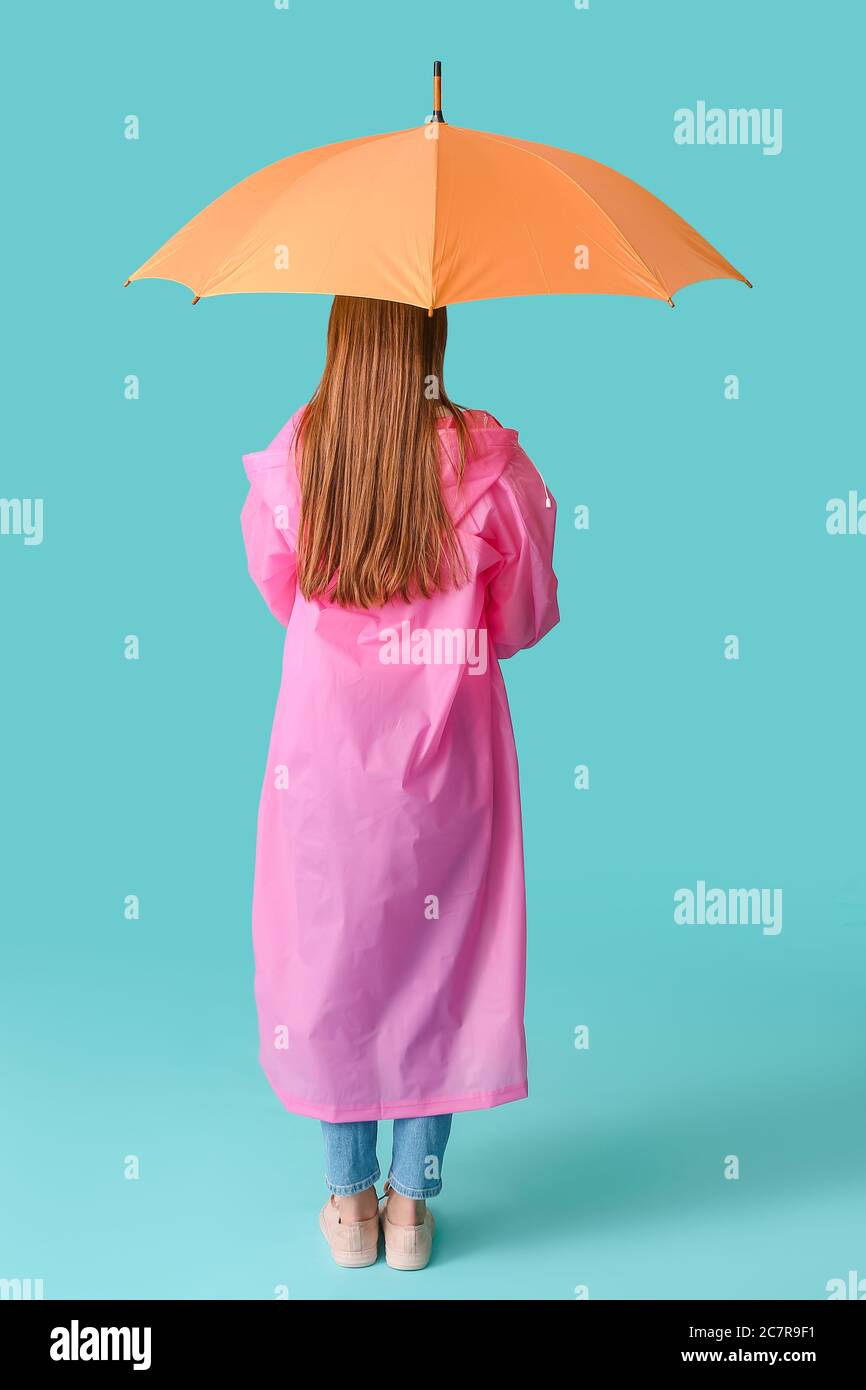 Beautiful woman with umbrella on color background, back view Stock ...