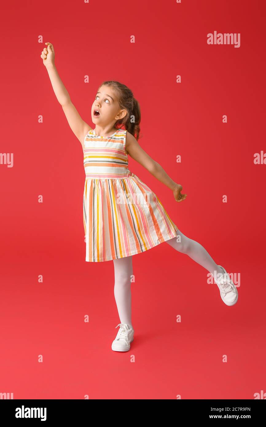 Cute little girl on color background Stock Photo - Alamy