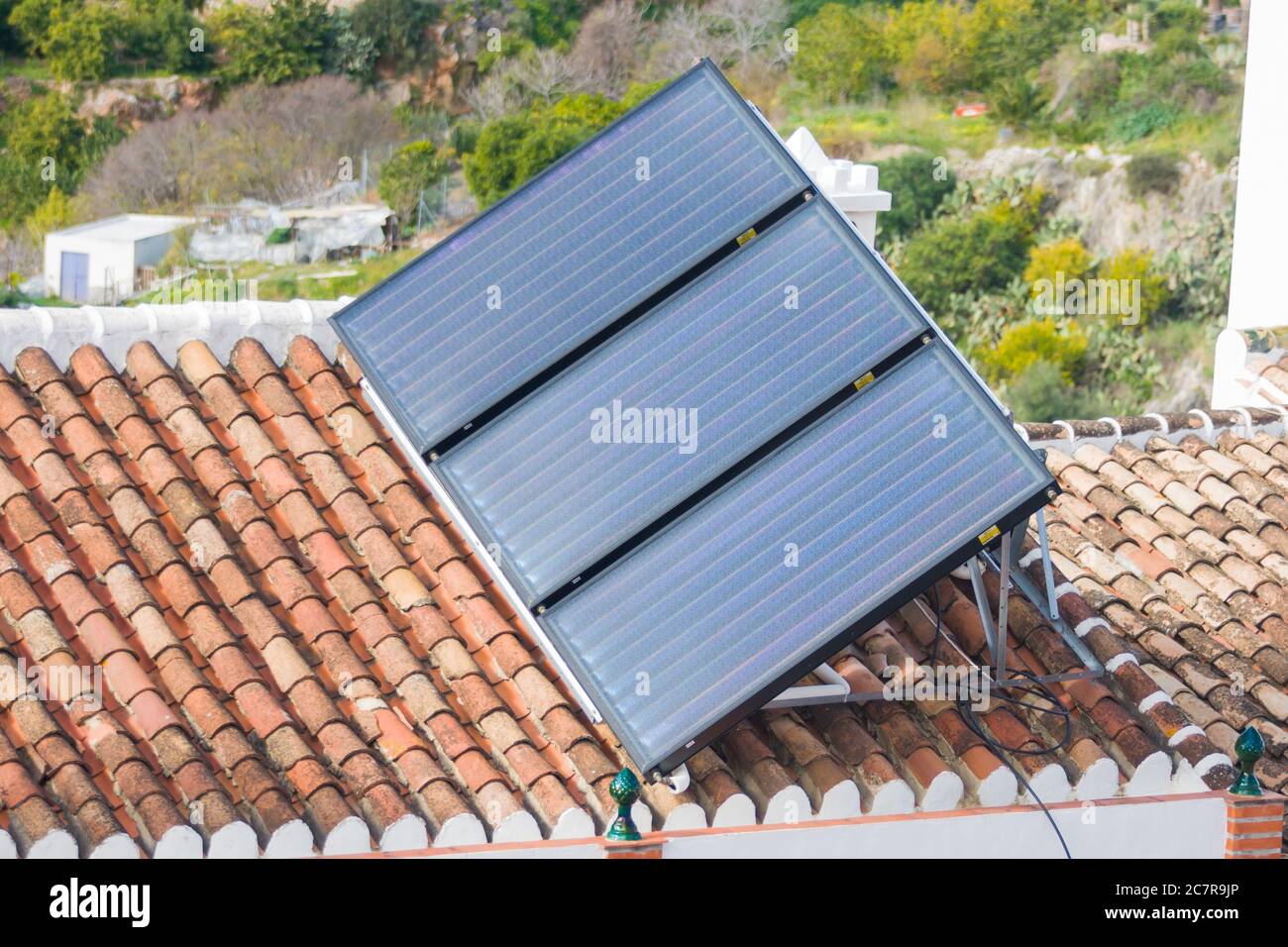 Side view of three large solar panels on a roof Stock Photo - Alamy